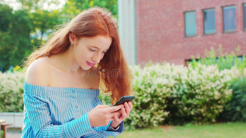 Lady Using a Phone Outdoors Stock Photo - Image of device, happy: 153558990