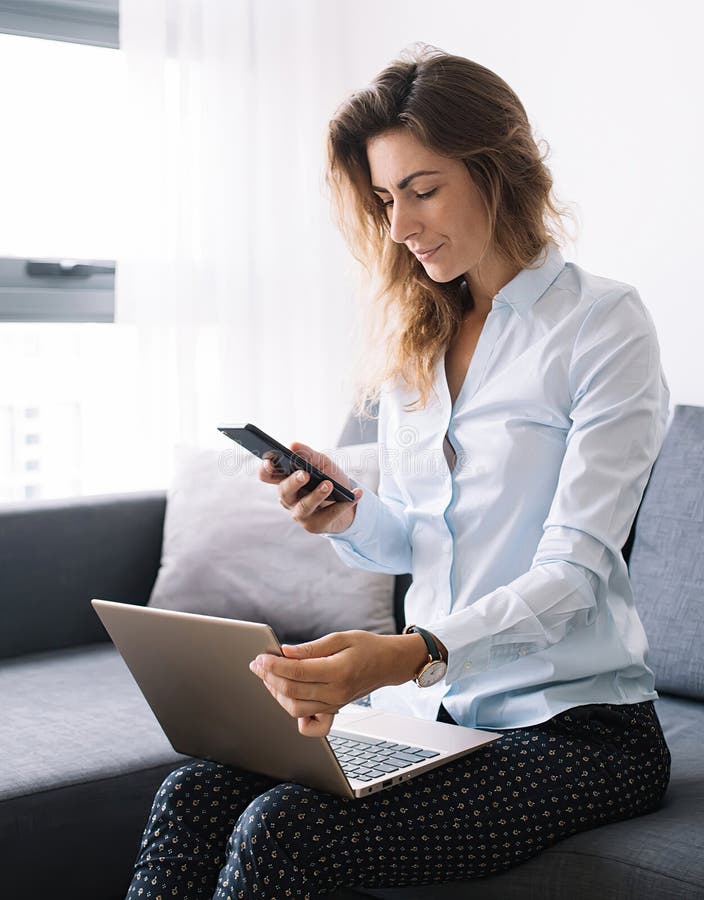 Lady Using Phone Sitting with Laptop on Sofa Stock Image - Image of ...