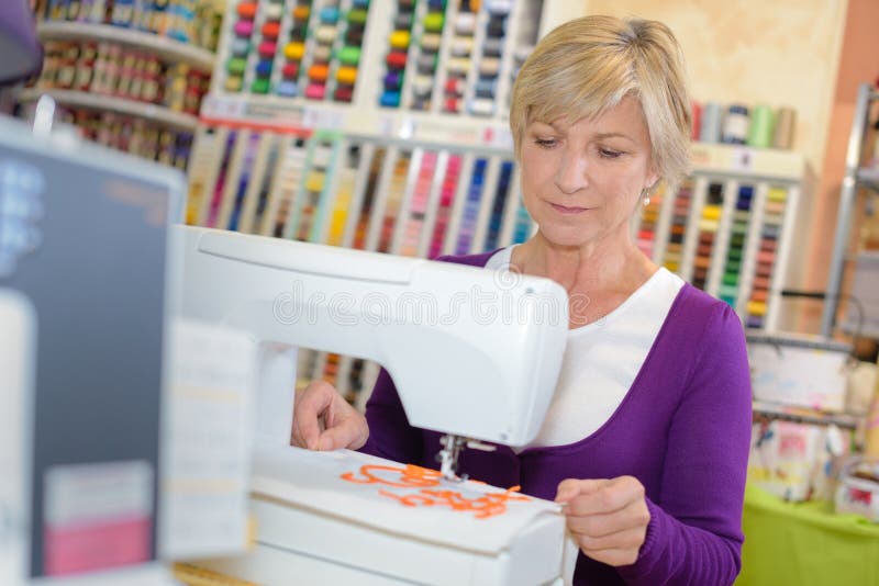 Lady sat at sewing machine stock photo. Image of labourer - 130823098