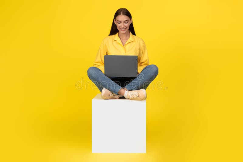 Lady Working on Laptop Computer Smiling Sitting Over Yellow Background ...