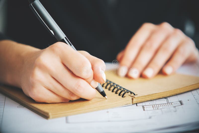 Lady writing in notepad stock photo. Image of female - 81480682
