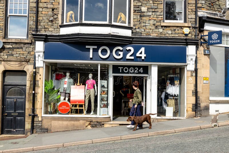 Fashion Storefront of Tog 24 with Dog and Pedestrian Passing by, on a ...