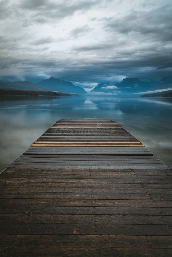 Lake Dock Overlooking a Reflective Lake. Stock Photo - Image of ...