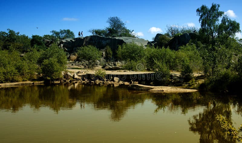 Pond Surrounded by Rocks and Greenery Stock Photo - Image of rocks ...