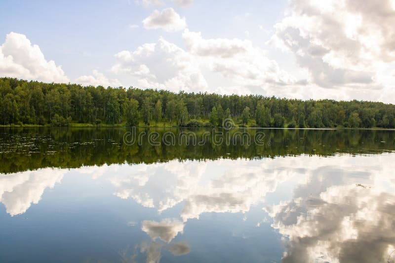 Lake in the Forest. Reflection of Clouds in the Water Surface. Stock ...