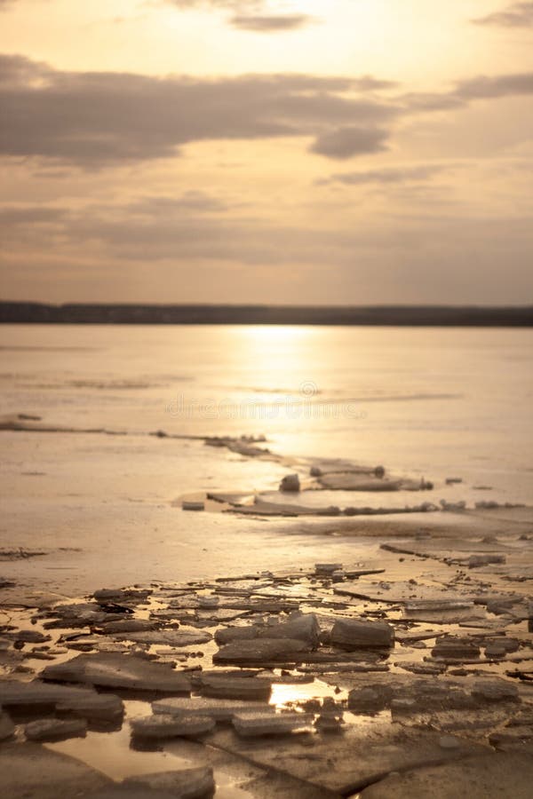 A Lake with Ice and Ice in it and the Sun Reflecting on the Water Stock ...