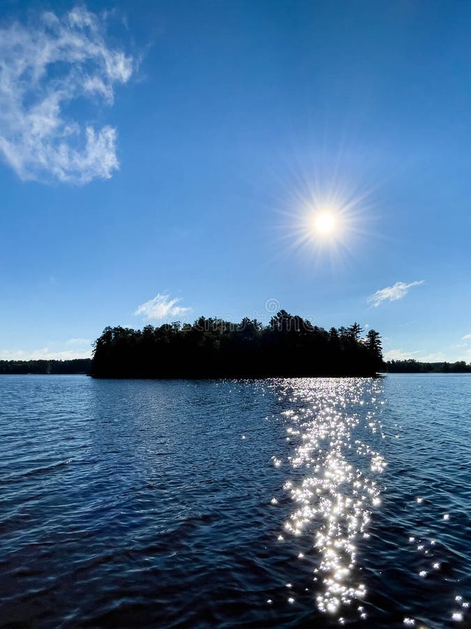 Lake with an Island and the Sun Shinning on the Water Stock Image ...