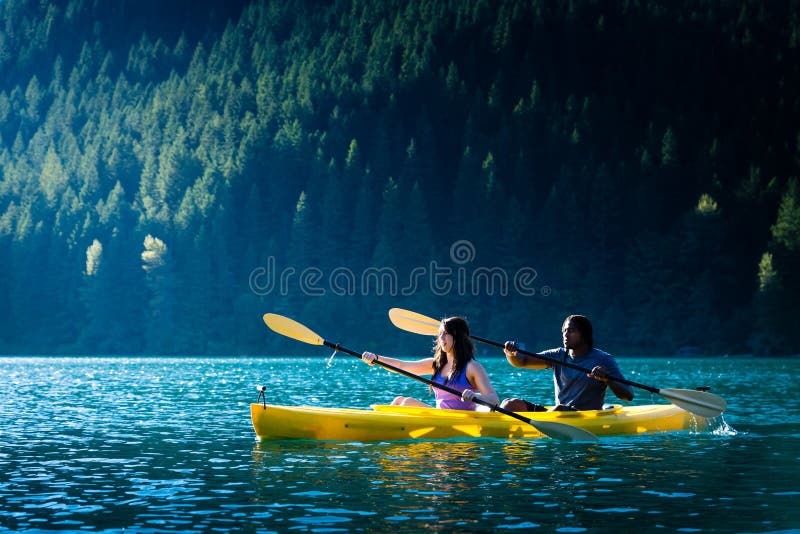 Lake Kayaking Couple stock photo. Image of boat, male - 27130118