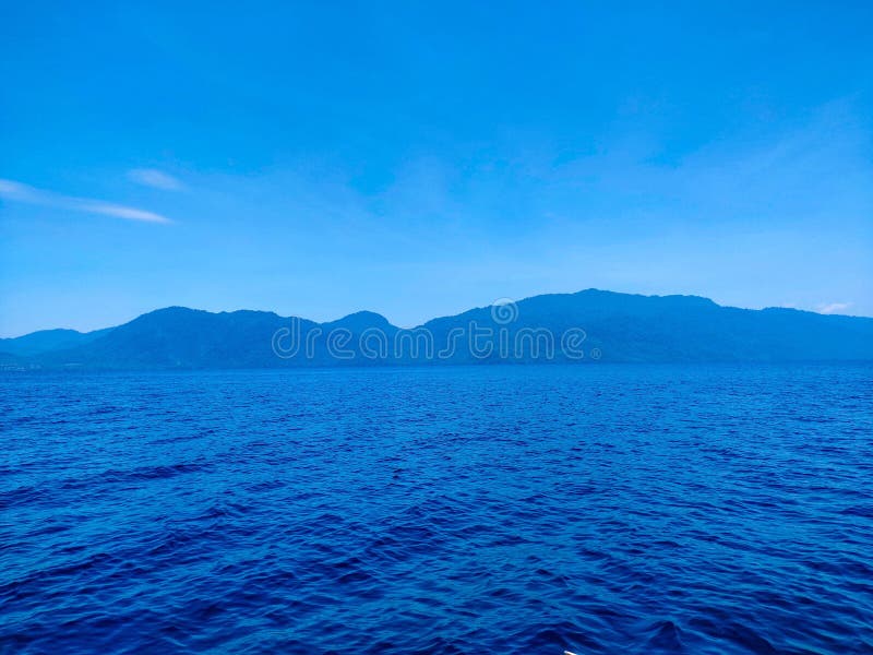 Lake Matano with Deep Blue Water and Clear Sky Stock Image - Image of ...