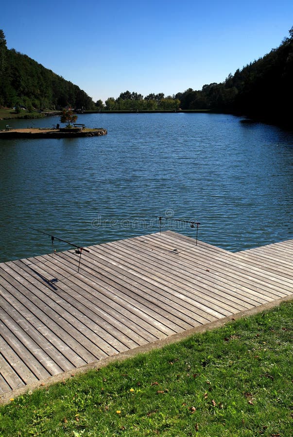 Lake with pier stock image. Image of pier, hill, grass - 27978209