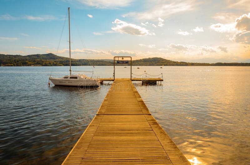 Lake Pier with Boat at Sunset Stock Photo - Image of sunset, sunbeam ...