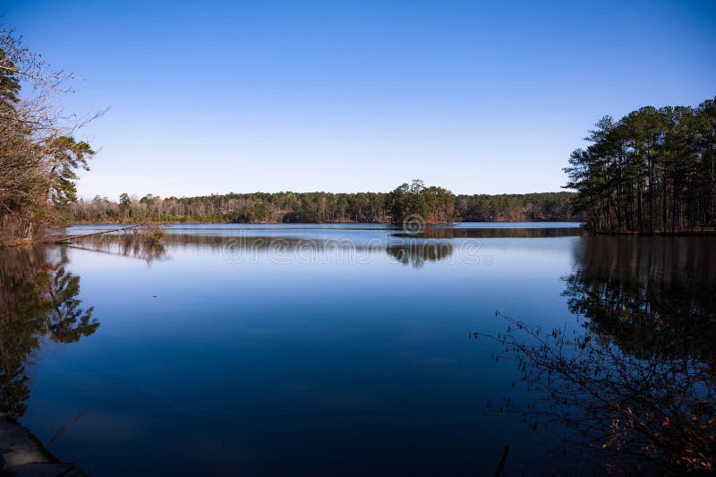A Lake with a Pier and a Tree Line at the Side Editorial Stock Image ...