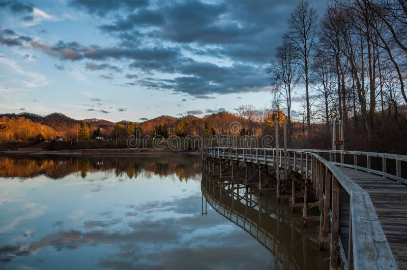 Lake Reflection at Sunset with Pier Dock Foot Path Stock Photo - Image ...