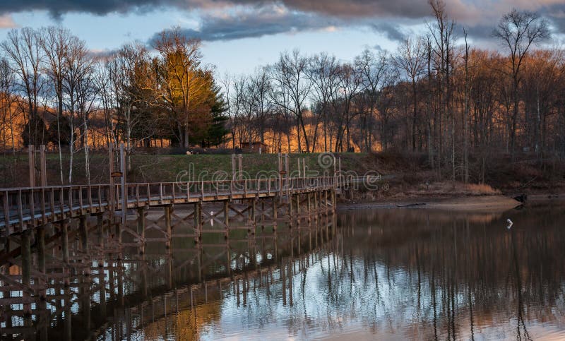 Lake Reflection at Sunset with Pier Dock Foot Path Stock Image - Image ...