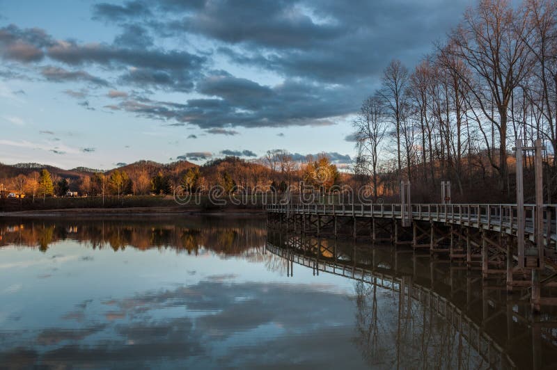 Lake Reflection at Sunset with Pier Dock Foot Path Stock Photo - Image ...