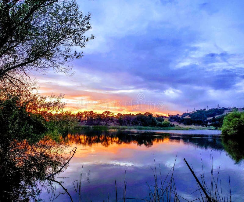 Lake reflections by sunset stock image. Image of sunset - 177401683