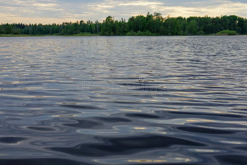 Lake with Ripples and Reflections at Sunset Stock Photo - Image of ...