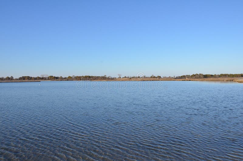 A Lake or River with Brown Grasses and Shore Stock Image - Image of ...