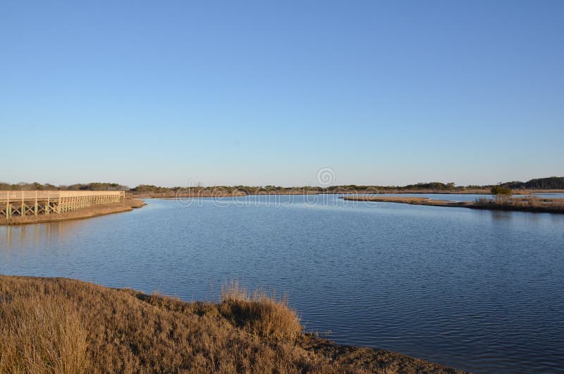 A Lake or River with Brown Grasses and Shore Stock Image - Image of ...