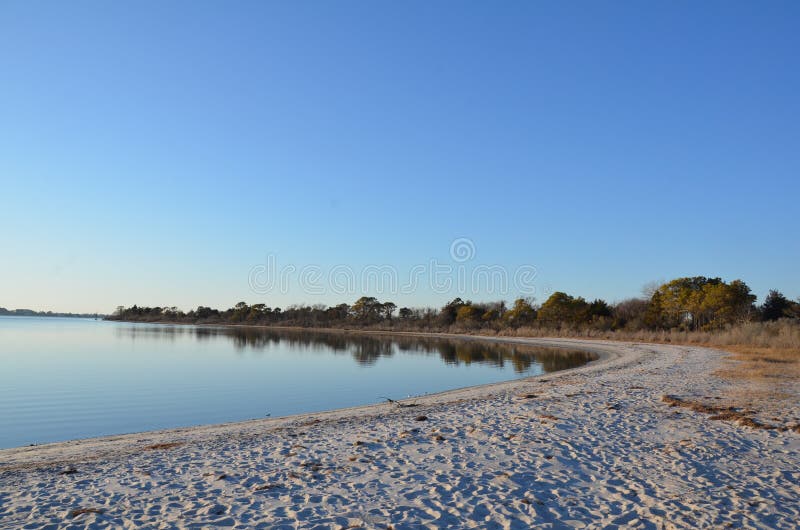 A Lake or River with Brown Grasses and Shore with Sand Stock Photo ...