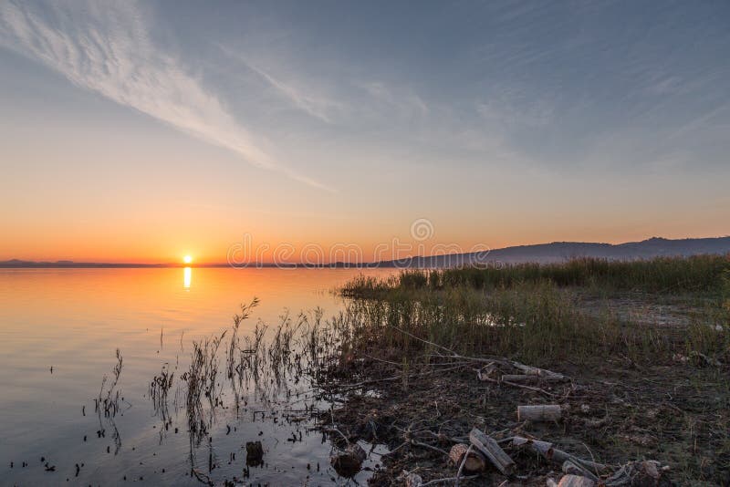 Lake Shore at Sunset with Sun Reflecting on Water Stock Image - Image ...
