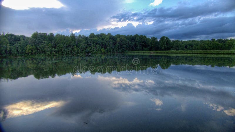 Lake Showing Its Reflection with the Sun , Sky and Clouds Stock Photo ...