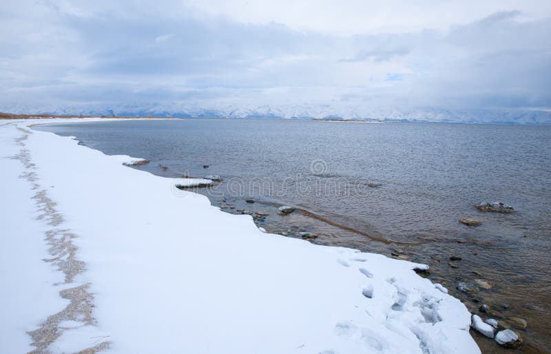 Lake with Snowy Beach and Mountain Stock Image - Image of clouds, ocean ...