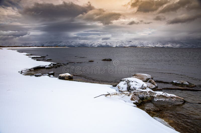 Lake with Snowy Beach and Mountain Stock Image - Image of cold ...