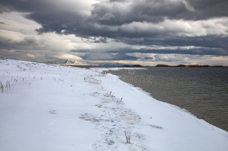 Lake with Snowy Beach and Mountain Stock Photo - Image of landscape ...