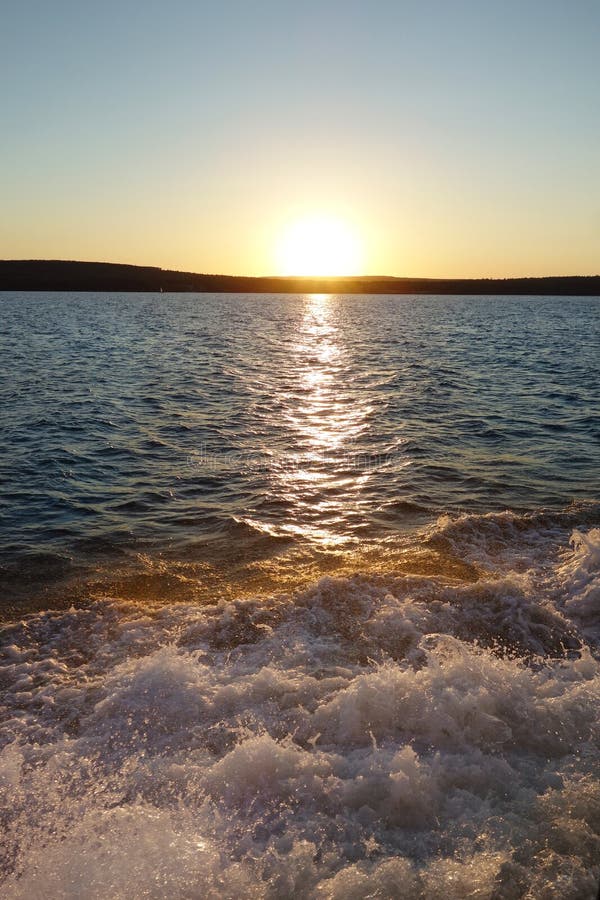 Lake Sunset with Boat Wake Waves Stock Photo - Image of sunset, waves ...