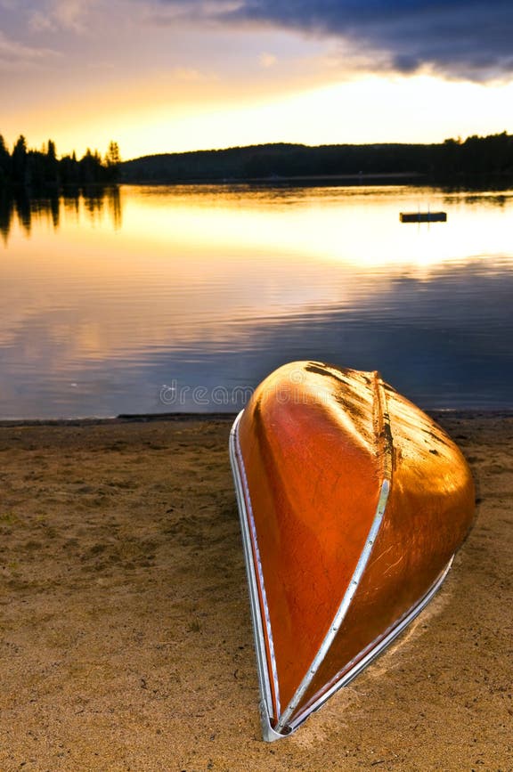 Lake Sunset with Canoe on Beach Stock Image - Image of relaxation ...