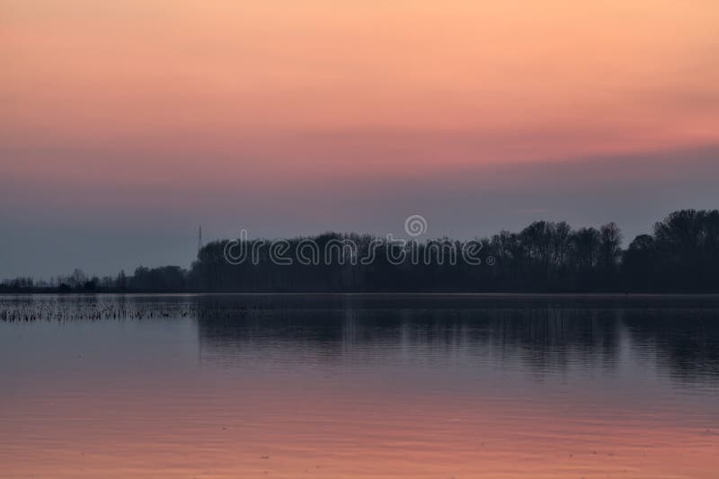 Lake at Sunset with a Forest in the Distance and the Sky Casted in the ...