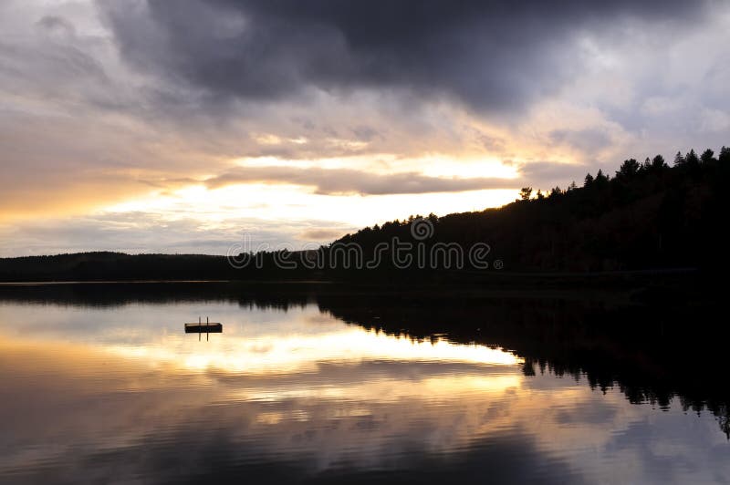 Lake Sunset with Canoe on Beach Stock Photo - Image of peaceful, beach ...