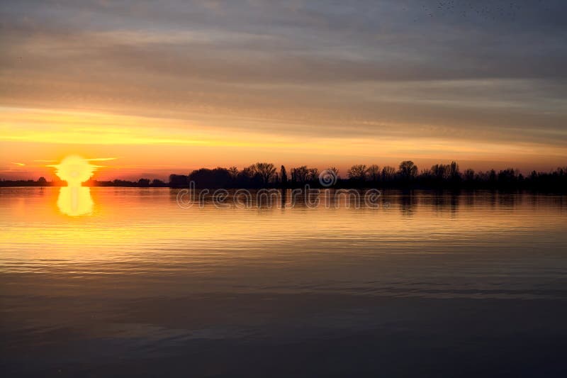 Lake at Sunset with the Sky Casted in the Water Seen from the Shore ...