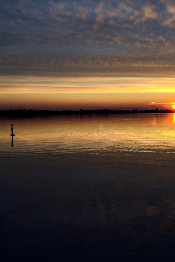 Lake at Sunset with the Sky Casted in the Water Seen from the Shore ...