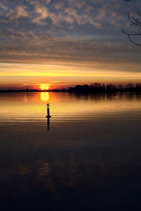 Lake at Sunset with the Sky Casted in the Water Seen from the Shore ...