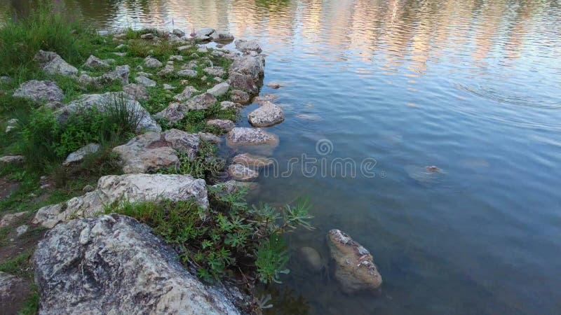 Lake Surface, Buildings Reflection and Rocks Stock Footage - Video of ...