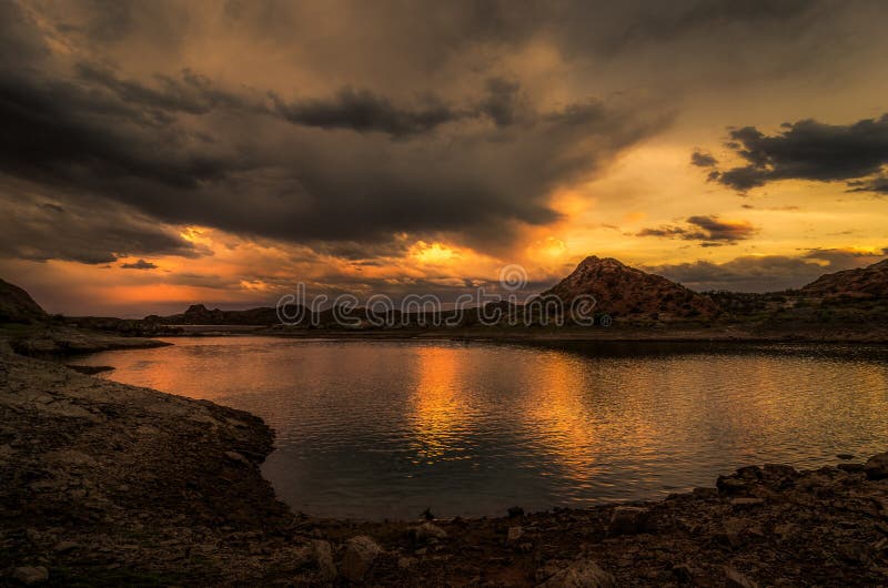 Lake Surrounded by Hills Gleaming Under the Beautiful Sunset Stock ...