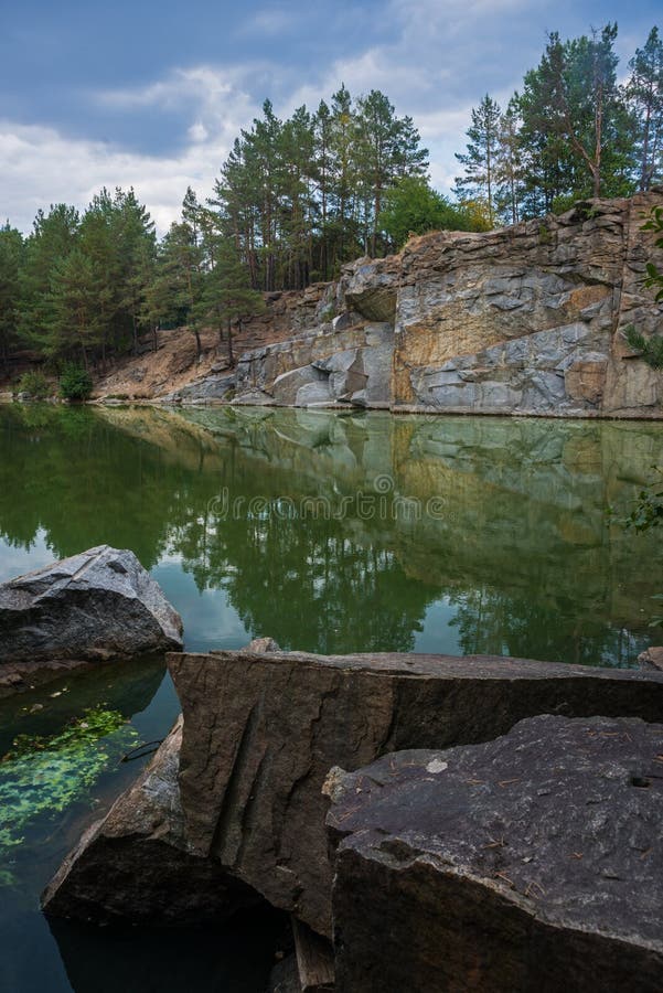Lake surrounded with rocks stock photo. Image of summer - 59883206