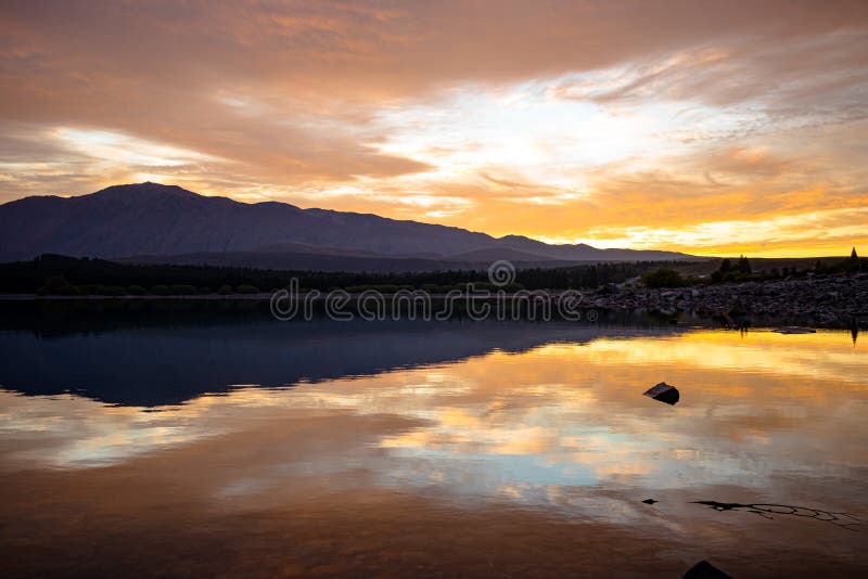 Lake Tekapo in the Glow of the Spring Sunrise Stock Image - Image of ...