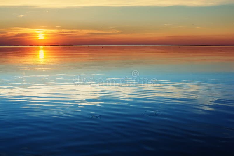 Lake tranquil sunset stock photo. Image of yellow, sunset - 76291486