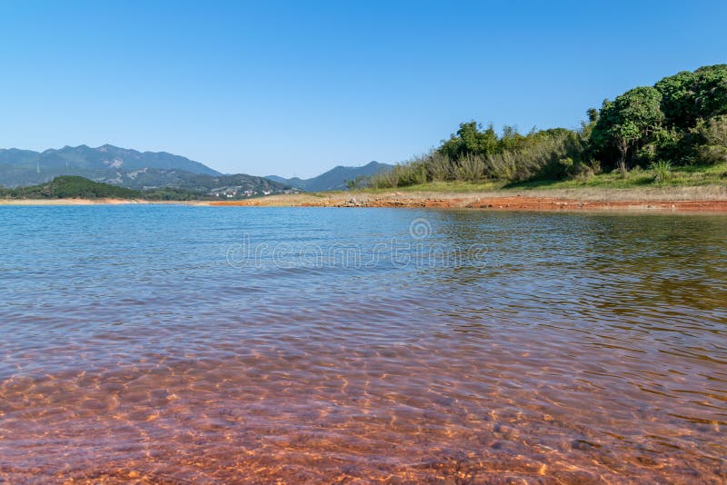 The Lake Under the Blue Sky Has Blue Water and Red Land Stock Photo ...
