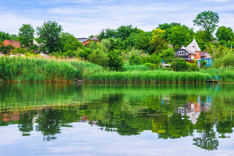 Lake View. the Lake Reflects the House, Reeds and Trees Stock Photo ...