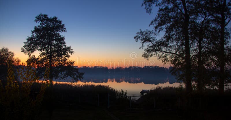 Lake view at sunset hour stock photo. Image of outdoor - 130452172