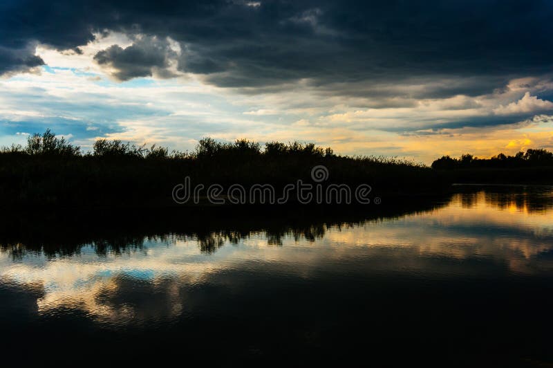 Lake water reflecting sky stock photo. Image of sunset - 51647420