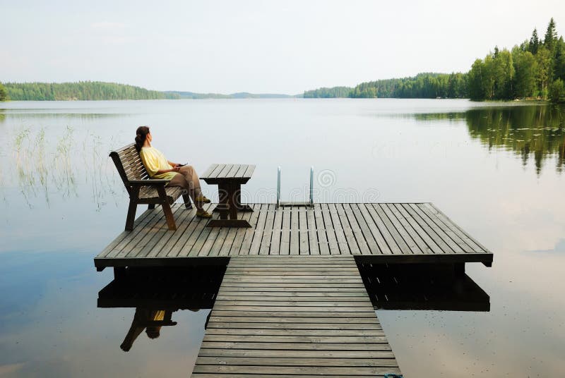 Lake with Wooden Platform and Woman Resting. Stock Photo - Image of ...