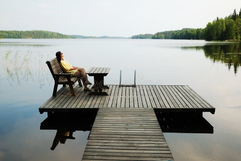 Lake with Wooden Platform and Woman Resting. Stock Photo - Image of ...