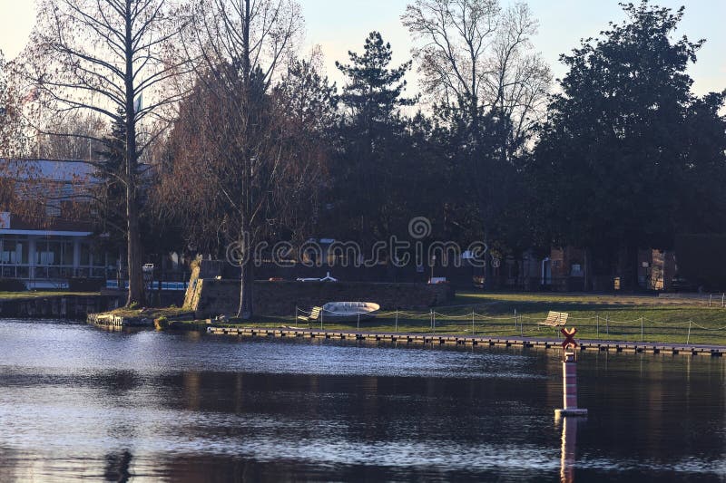 Lakeshore in a Residential Area at Sunset with Reflection Casted in the ...