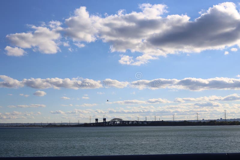 Lakeshore View with Clear Sky and Clouds Stock Image - Image of skyline ...