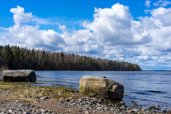 Lakeside Rocks and Forest Under a Cloudy Sky Stock Image - Image of ...